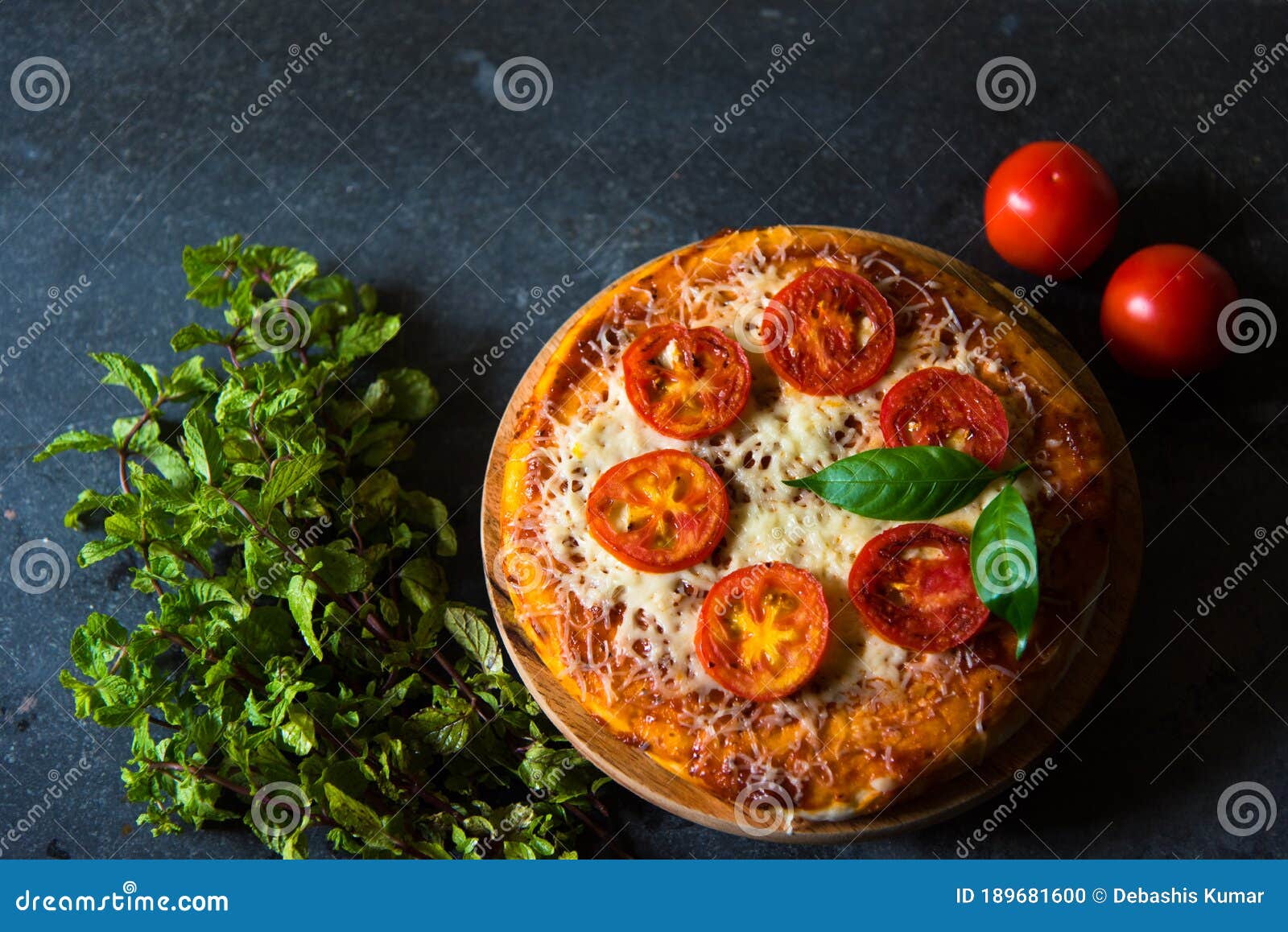 Pizza and Condiments of Tomatoes and Mint Leaves Stock Photo - Image of ...