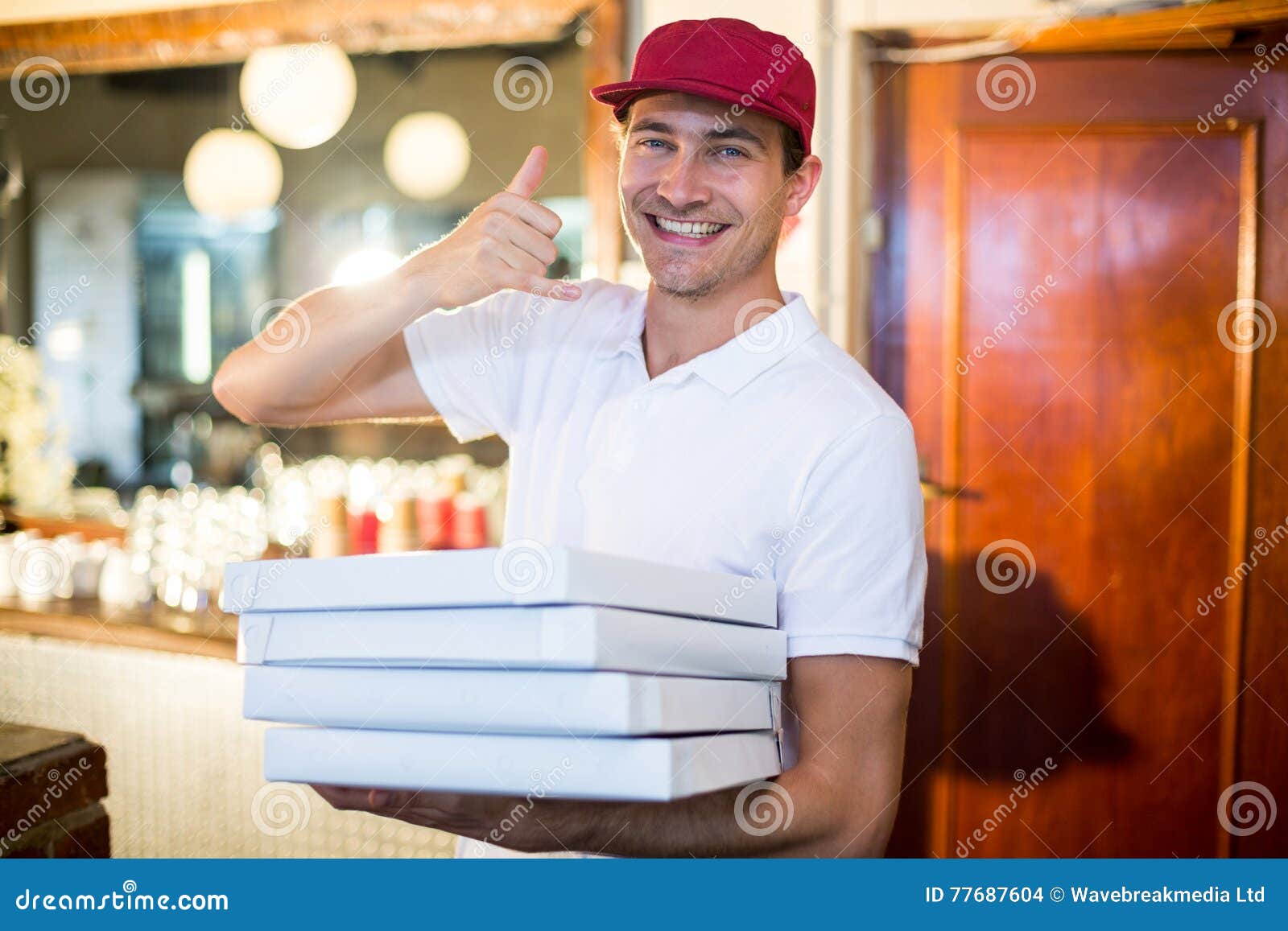 Pizza Delivery Man Holding Pizza Boxes Making a Phone Gesture Stock ...