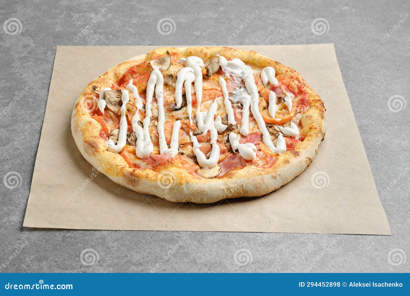 Pizza with Ham, Champignon and Tomato Slices on Parchment Paper Stock ...