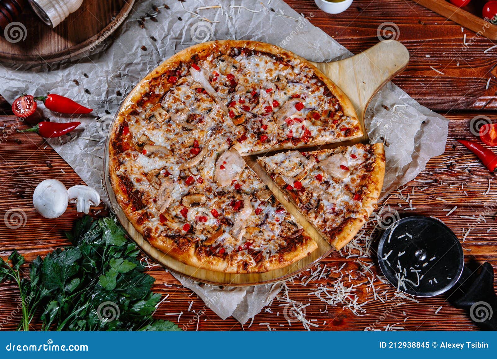 The Pizza is on the Kitchen Table, and the Ingredients are Scattered ...