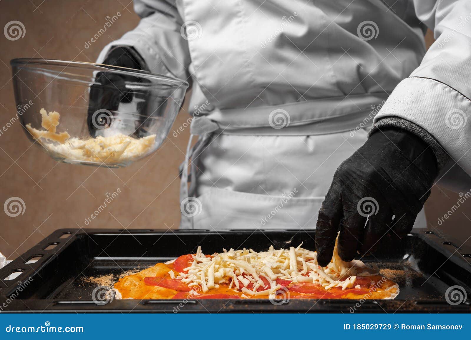 The Pizza Maker Sprinkles Grated Cheese on the Pizza Stock Image ...