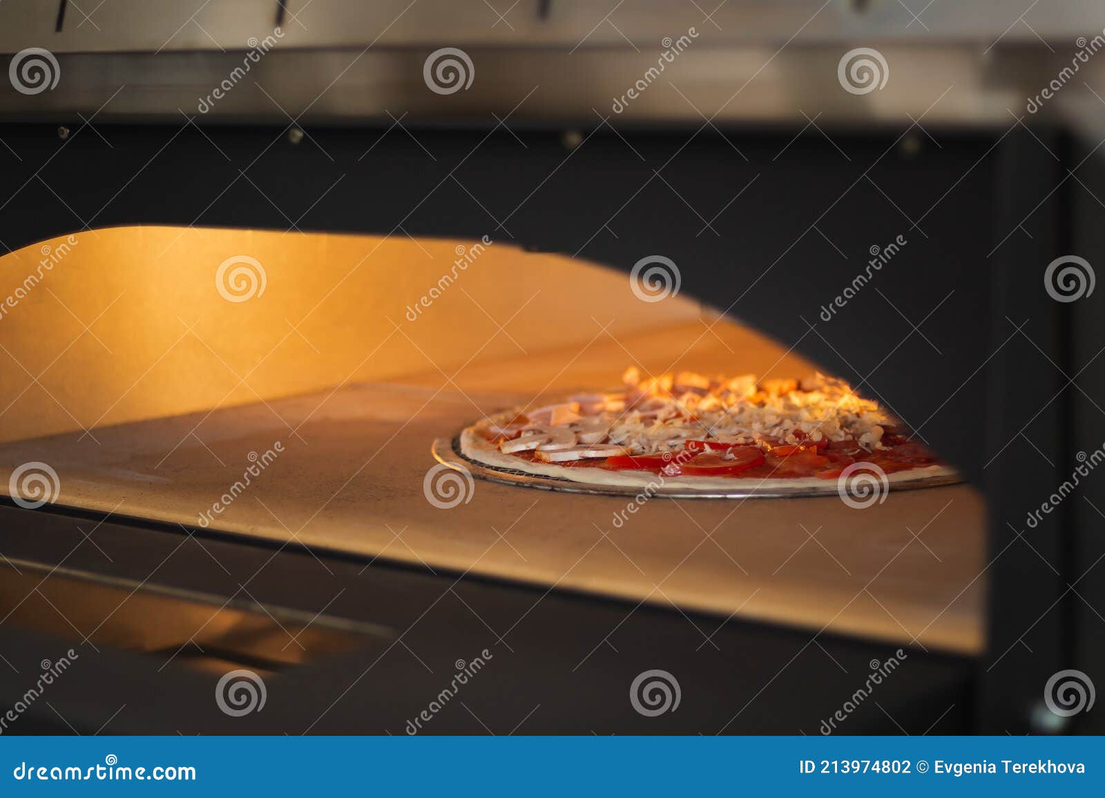 Pizza with Mushrooms, Tomatoes and Cheese on a Grid for Baking in the ...