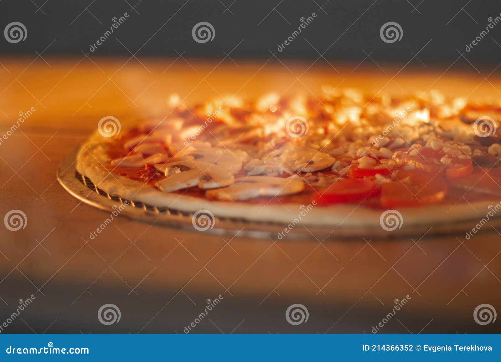 Pizza with Mushrooms, Tomatoes and Cheese on a Grid for Baking in the ...