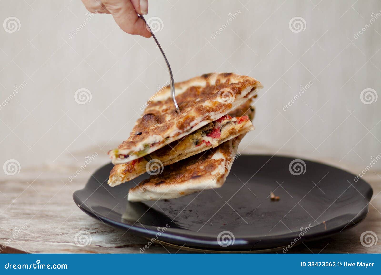 Pizza pieces on fork stock photo. Image of wall, finger - 33473662
