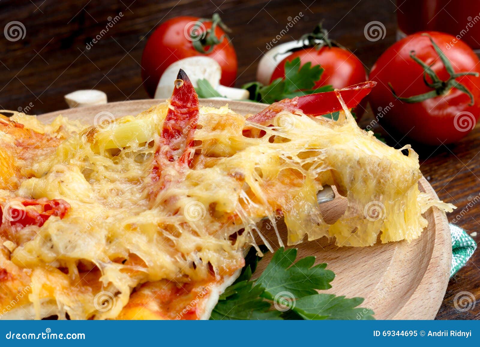 Pizza on a Wooden Table at Which Raise the Class with Stringy Cheese ...