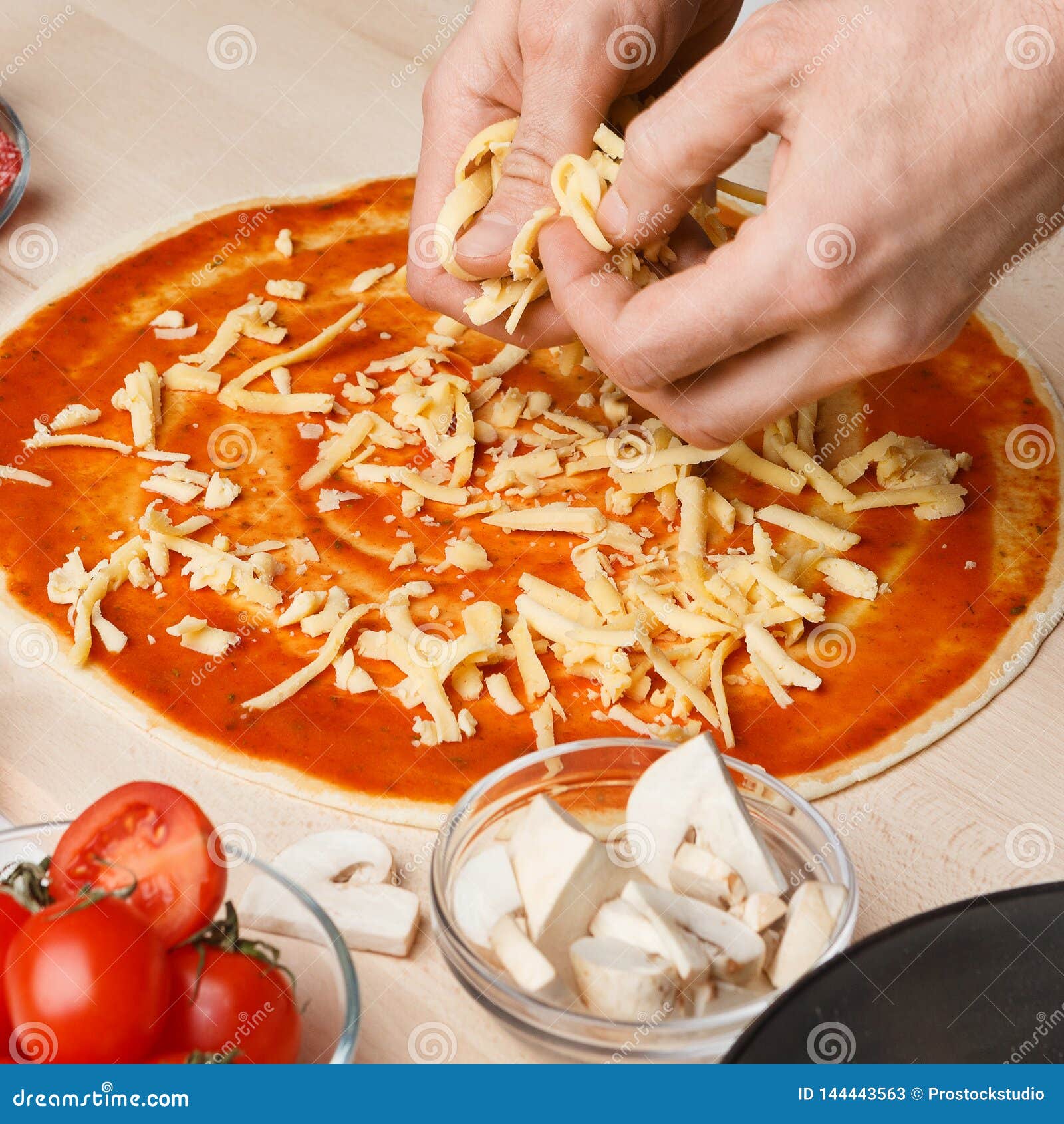 Pizzaiolo Adding Grated Cheese To Pizza Base Stock Image - Image of ...