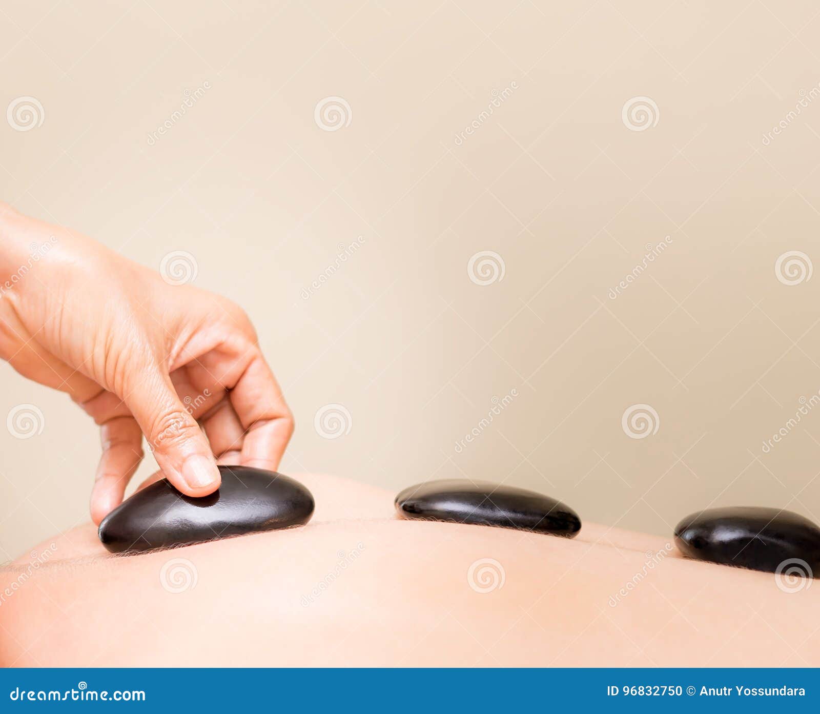 Placing Black Hot Stone on a Women Back Stock Photo - Image of glowing ...
