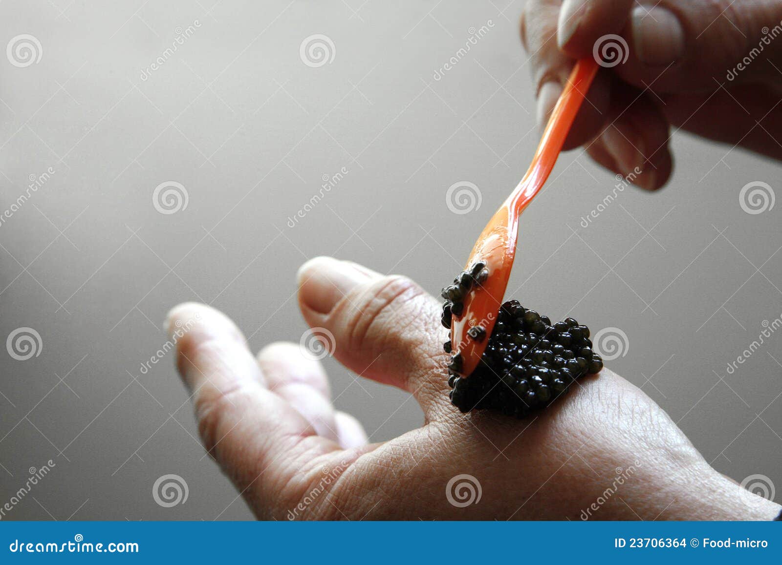Placing a Spoonful of Caviar on a Hand To Taste Stock Photo - Image of ...