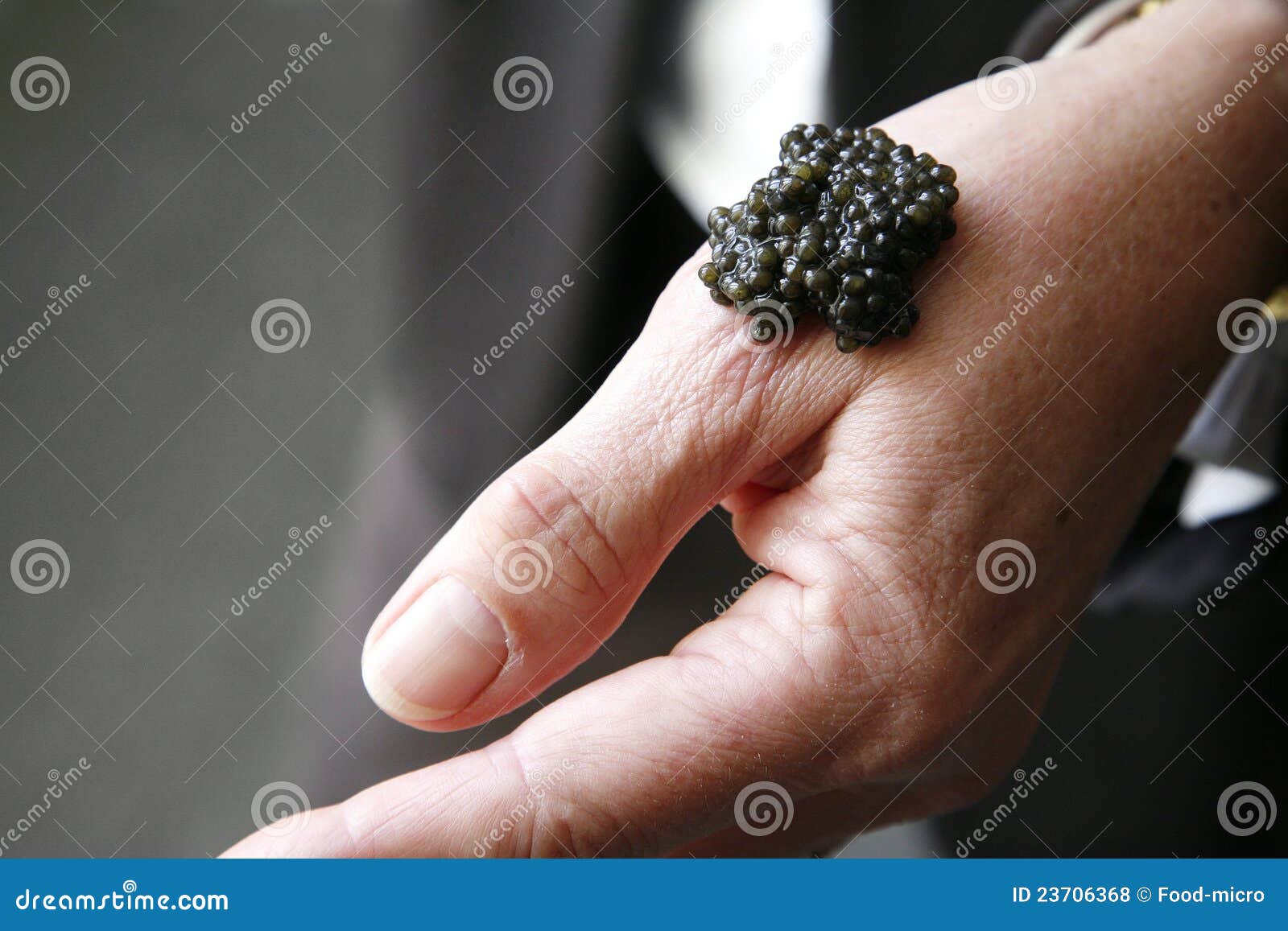 Placing a Spoonful of Caviar on a Hand To Taste Stock Photo - Image of ...