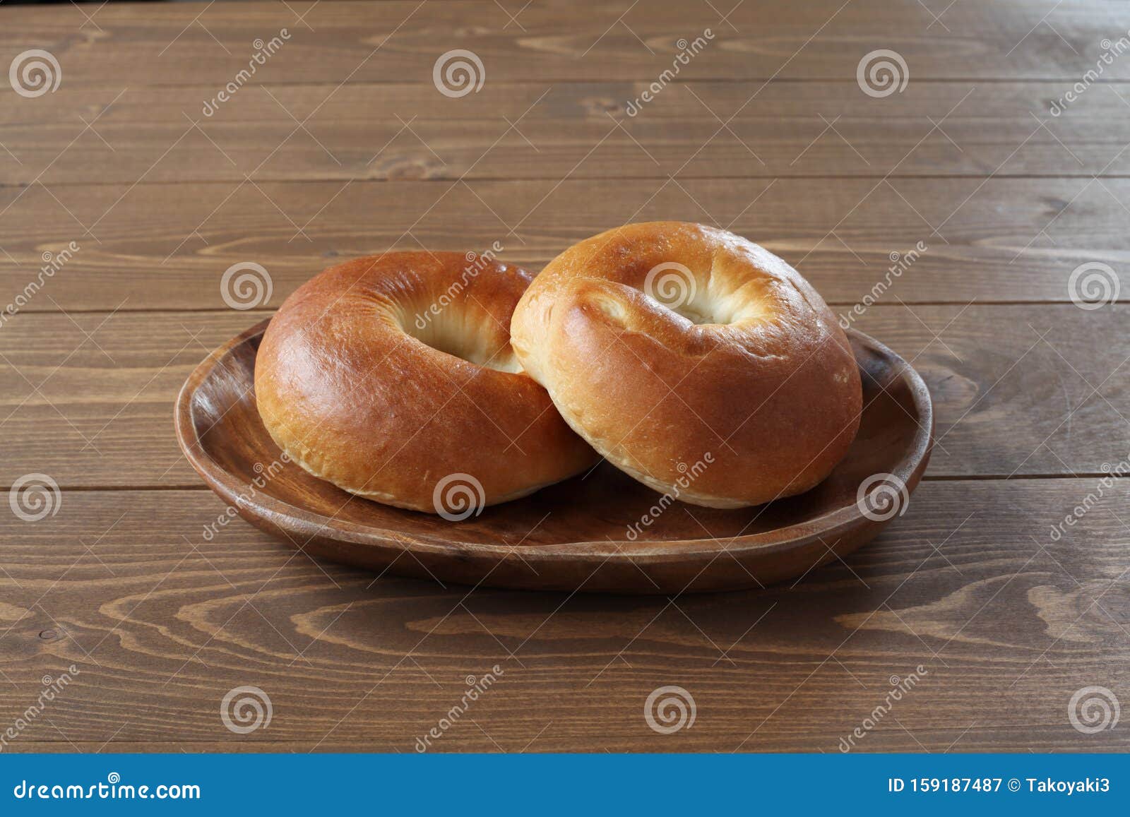 Plain Bagels Bread on Wooden Plate on Table Stock Image - Image of ...