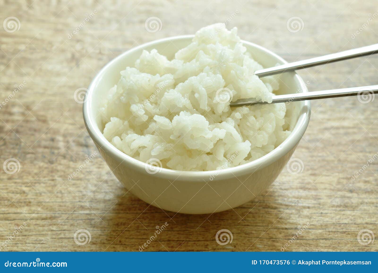 Plain Rice Scooping in Silver Chopticks on Cup Stock Photo - Image of ...