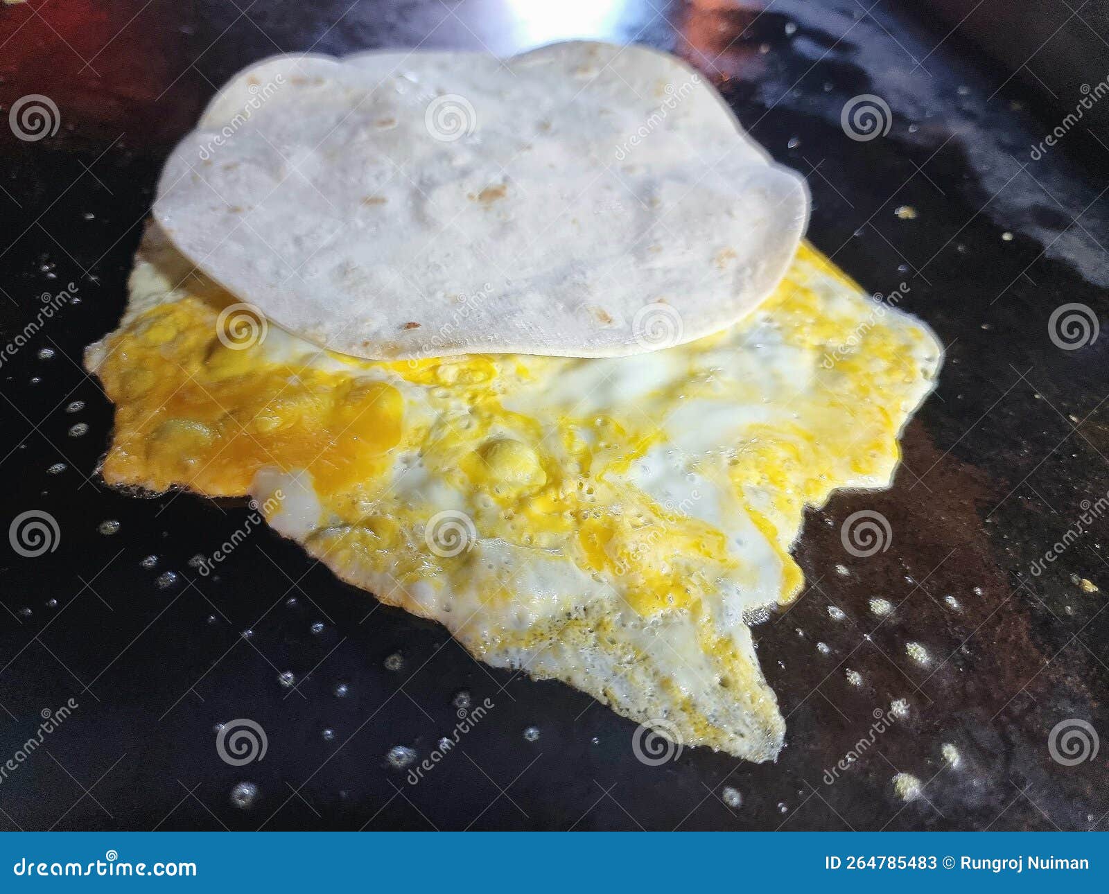 Plain Tortilla Wrap (Roti). Kebab are Being Cooked with Eggs on a Black ...