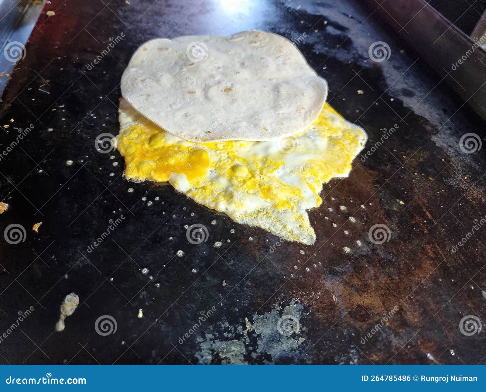 Plain Tortilla Wrap (Roti). Kebab are Being Cooked with Eggs on a Black ...