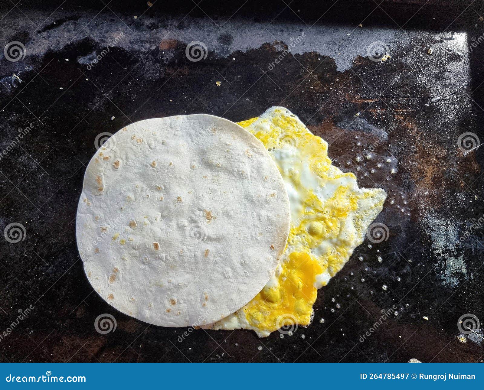 Plain Tortilla Wrap (Roti). Kebab are Being Cooked with Eggs on a Black ...