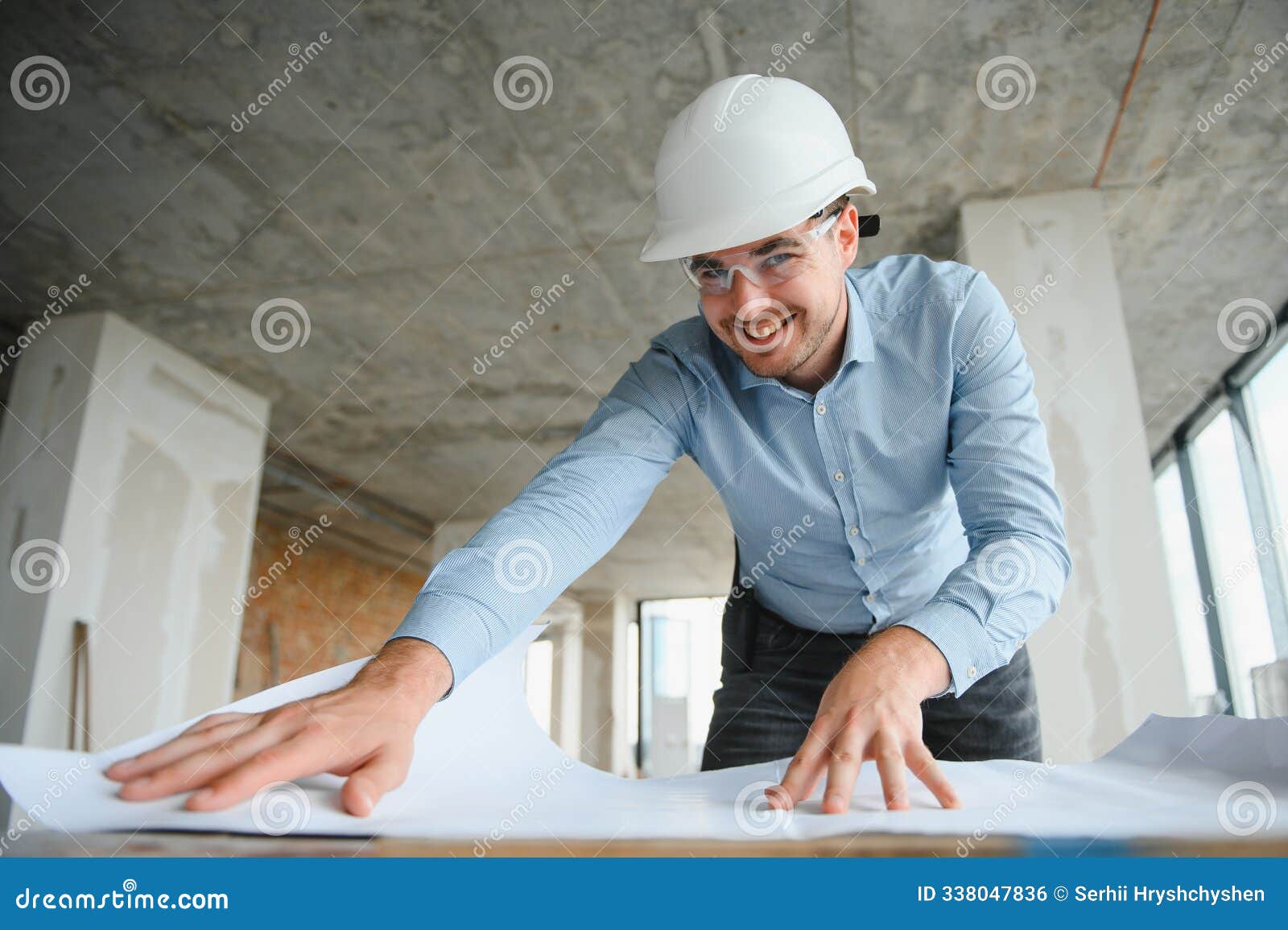 With Plan in Hands. Man in Uniform is Working on the Construction Site ...