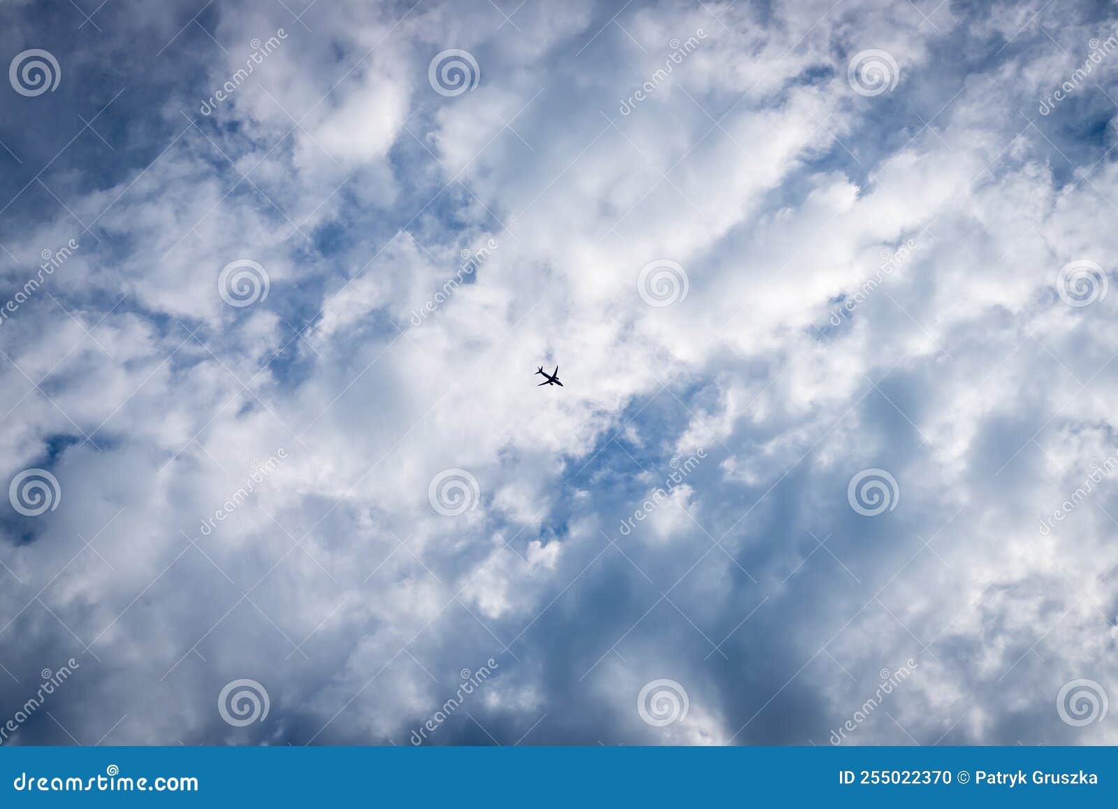 The Plane on a Background of the Blue Sky with Clouds. Plane Silhouette ...