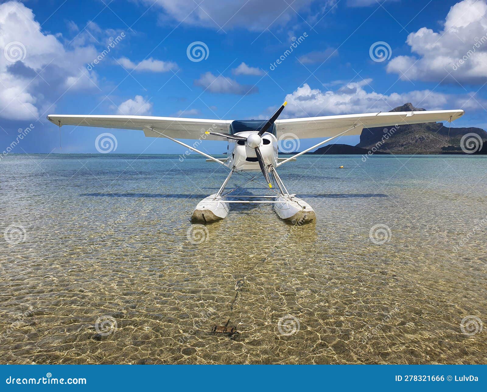 A Small Plane Parked in the Water Next To the Beach Stock Photo - Image ...