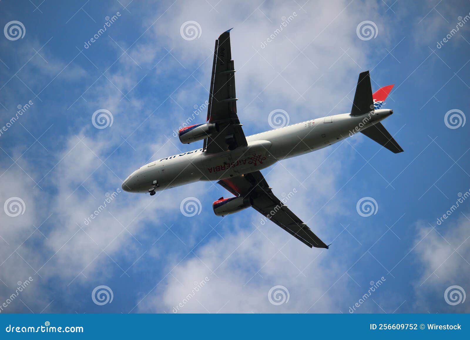 Plane Captured from Below with Clouds and Blue Sky in the Background ...