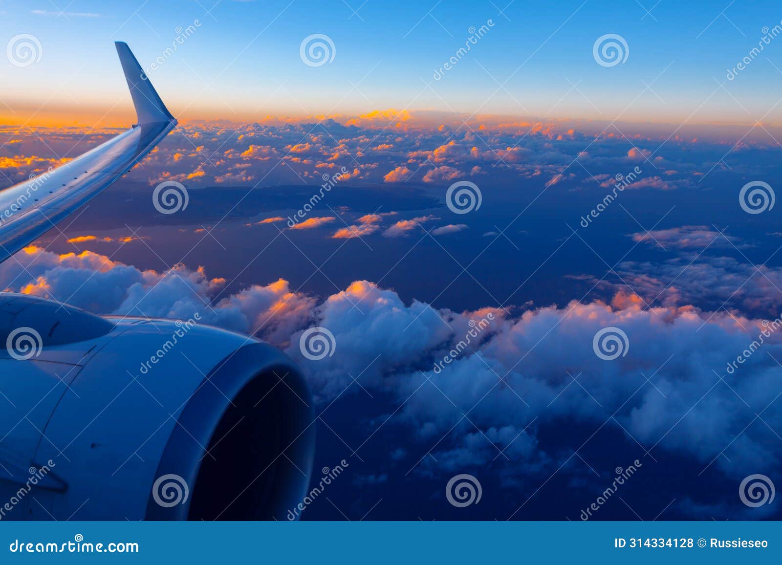 Plane Engine and Wing Soar Over Clouds in the Evening Stock Photo ...