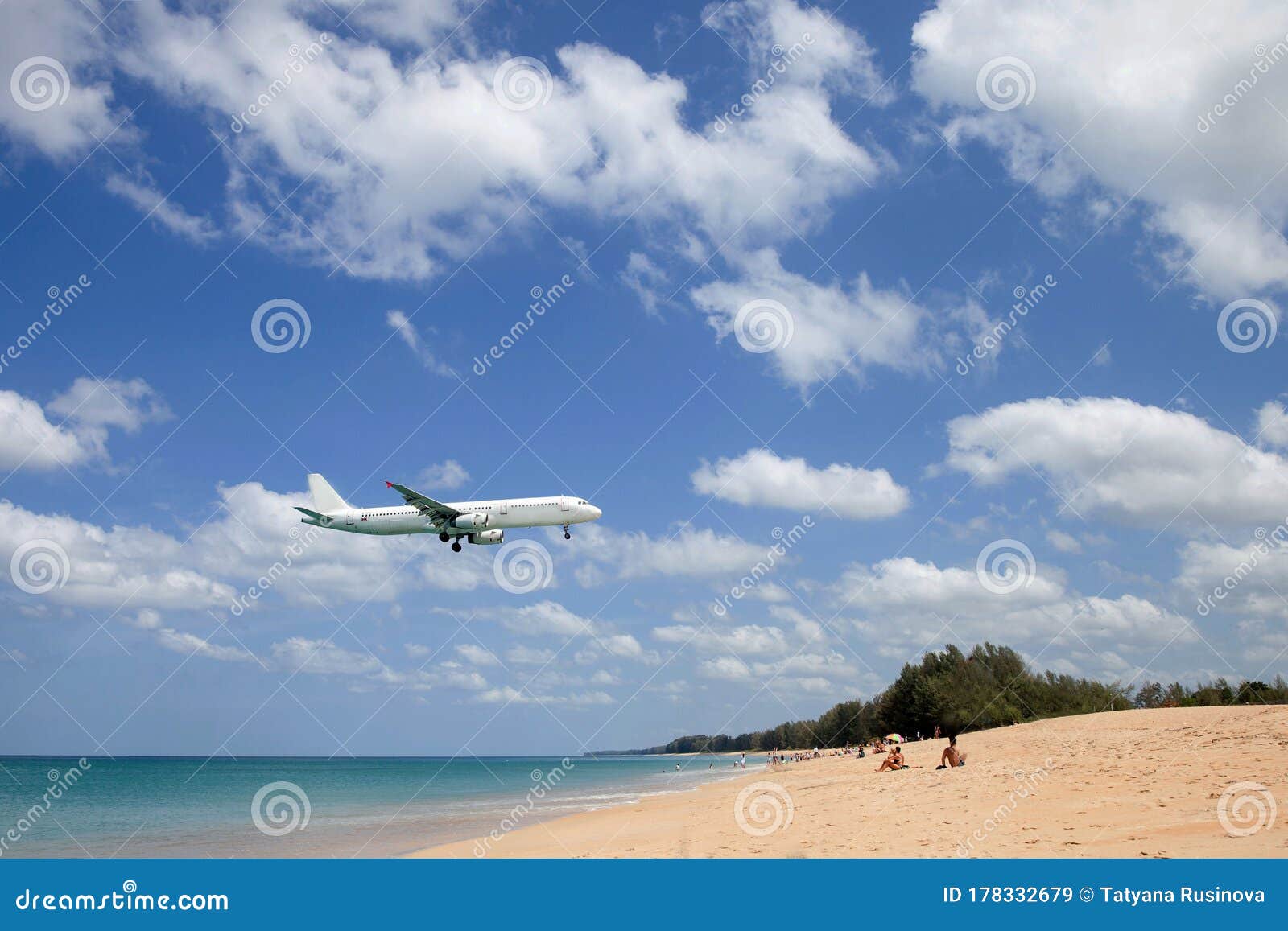 A Plane Flies Over the Beach with People on a Sunny Day Stock Image ...
