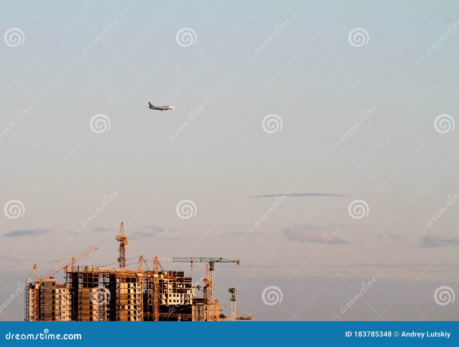 The Plane Flies Over a Construction Site with Cranes Stock Photo ...