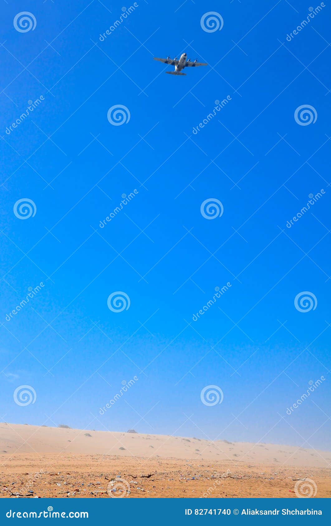Plane flies by over sands stock photo. Image of aviation - 82741740