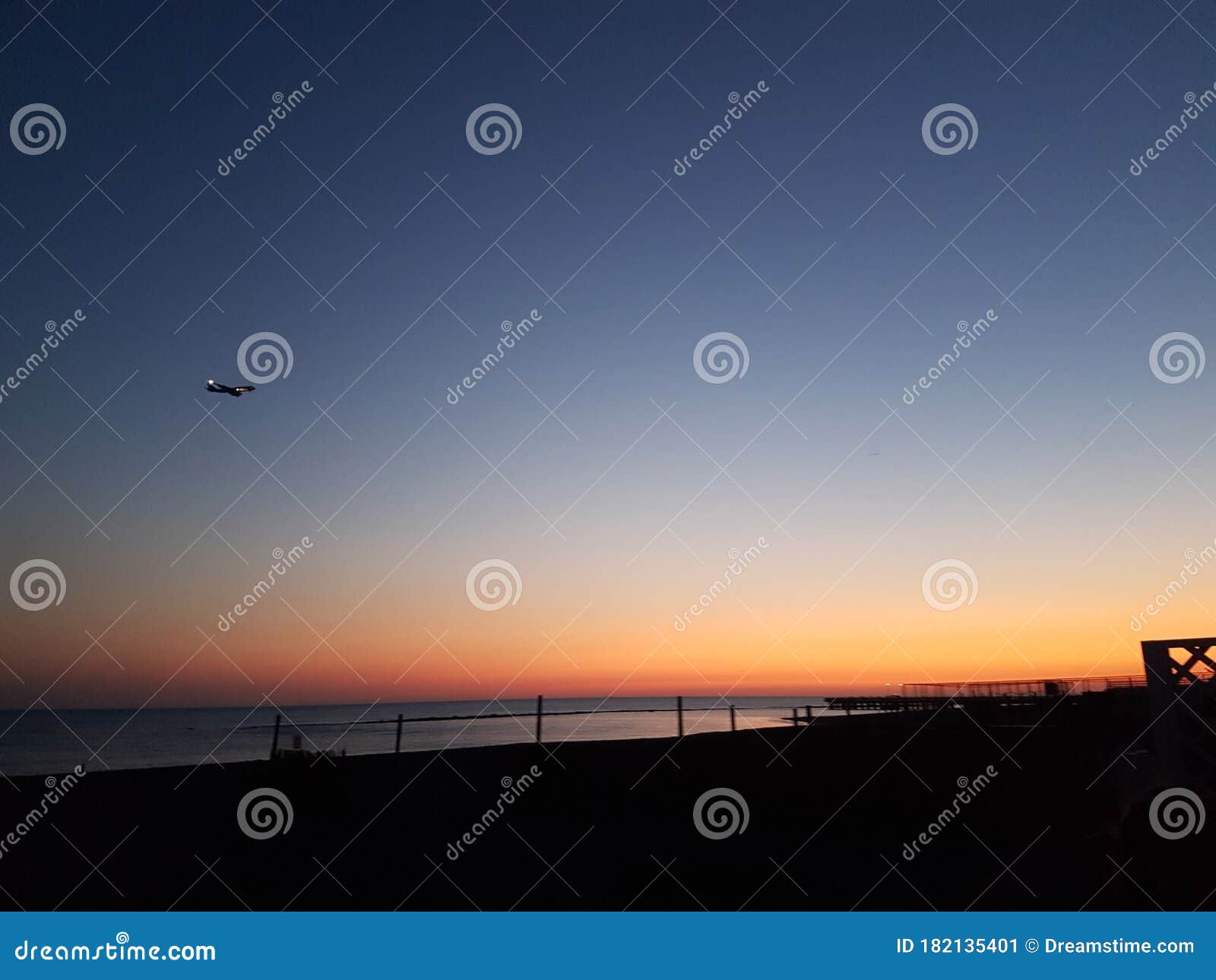A Plane Flying through a Beautiful Sunset Stock Image - Image of ...