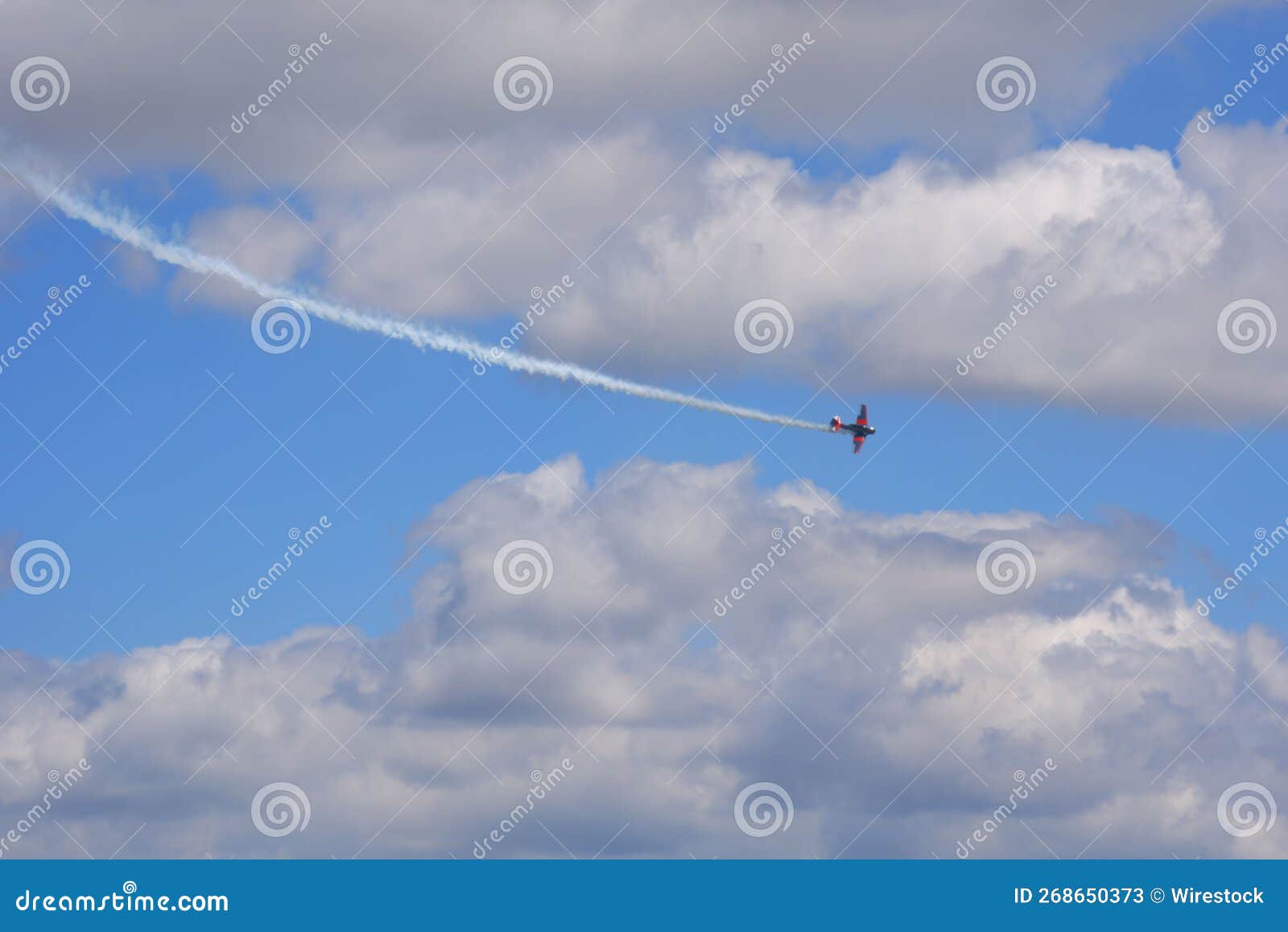 Plane Flying within Clouds in the Blue Sky with Clouds during an ...