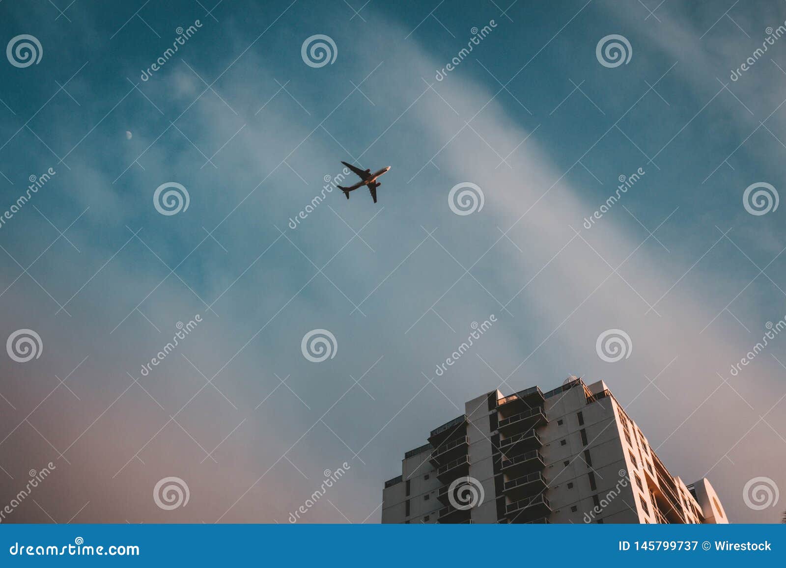 A Plane Flying Over a Building Stock Image - Image of beautiful ...
