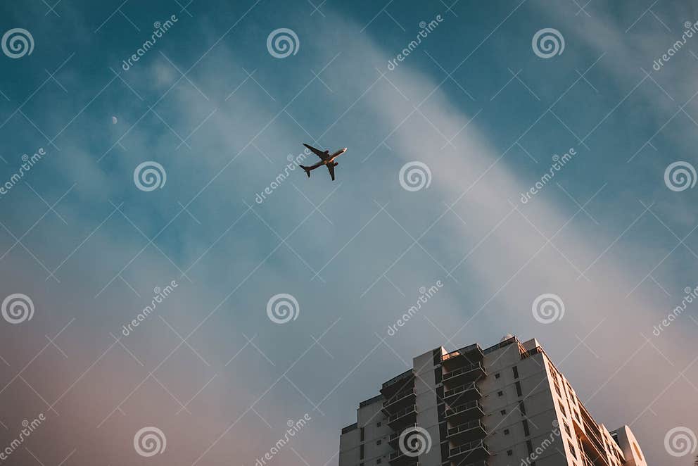 A Plane Flying Over a Building Stock Image - Image of beautiful ...