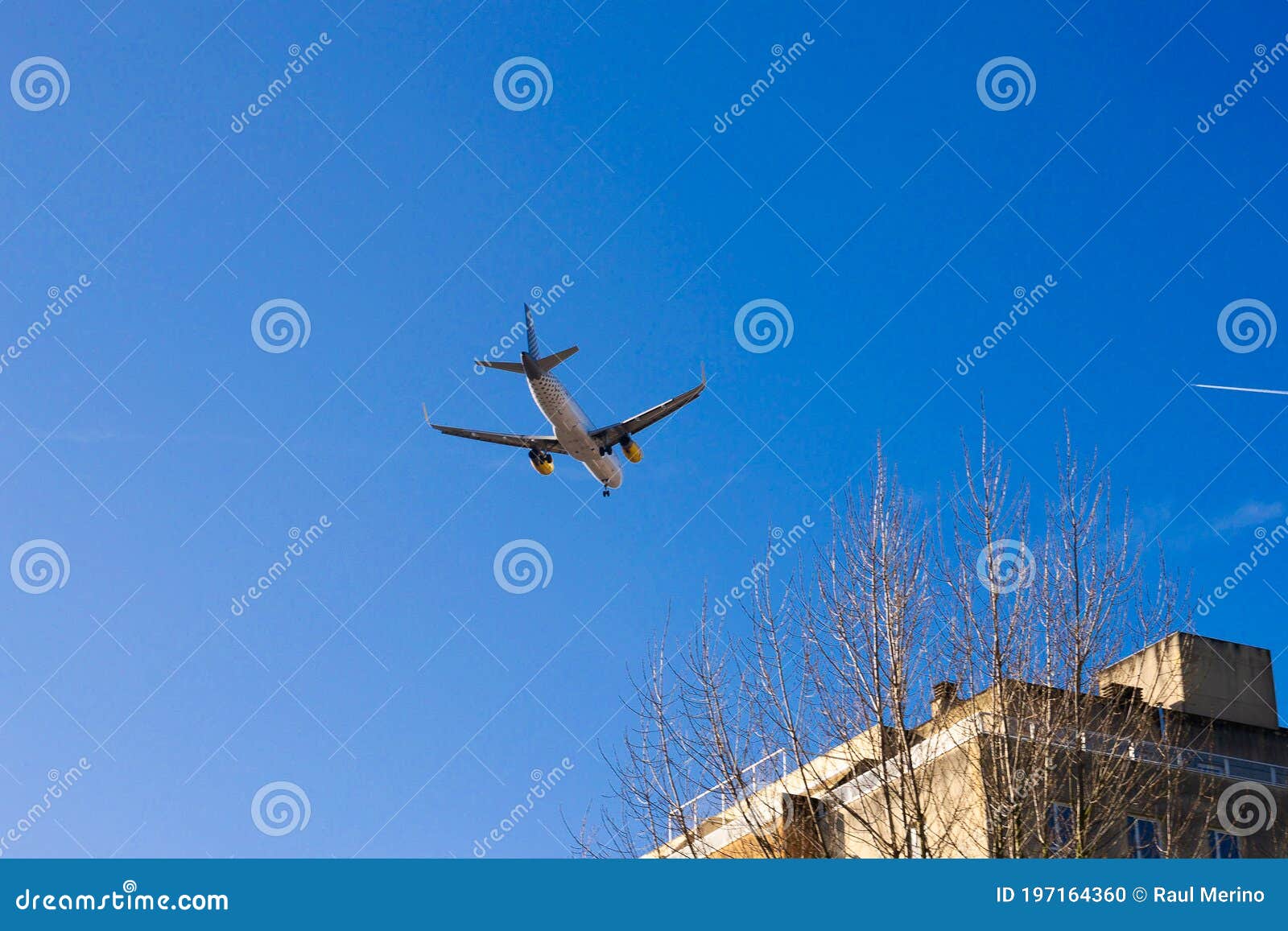 Plane Flying Over Buildings before Landing Stock Photo - Image of huge ...