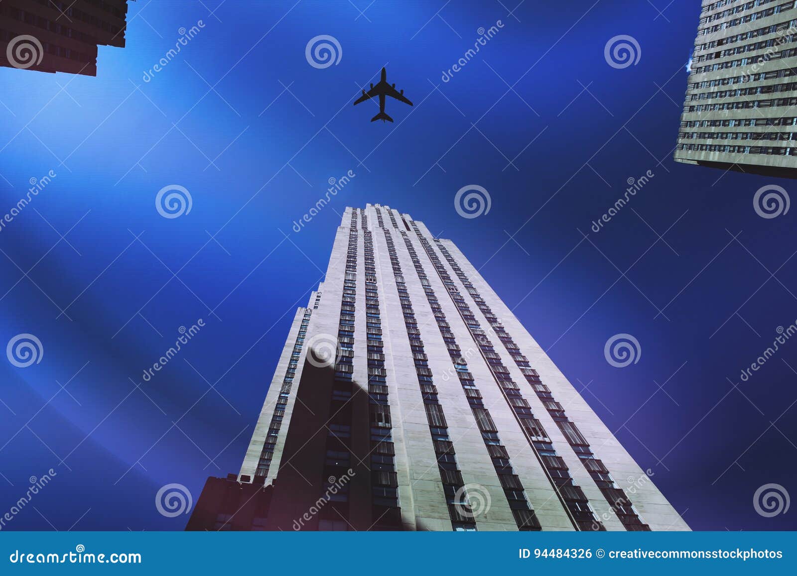 Plane Flying Over A Skyscraper Picture. Image: 94484326