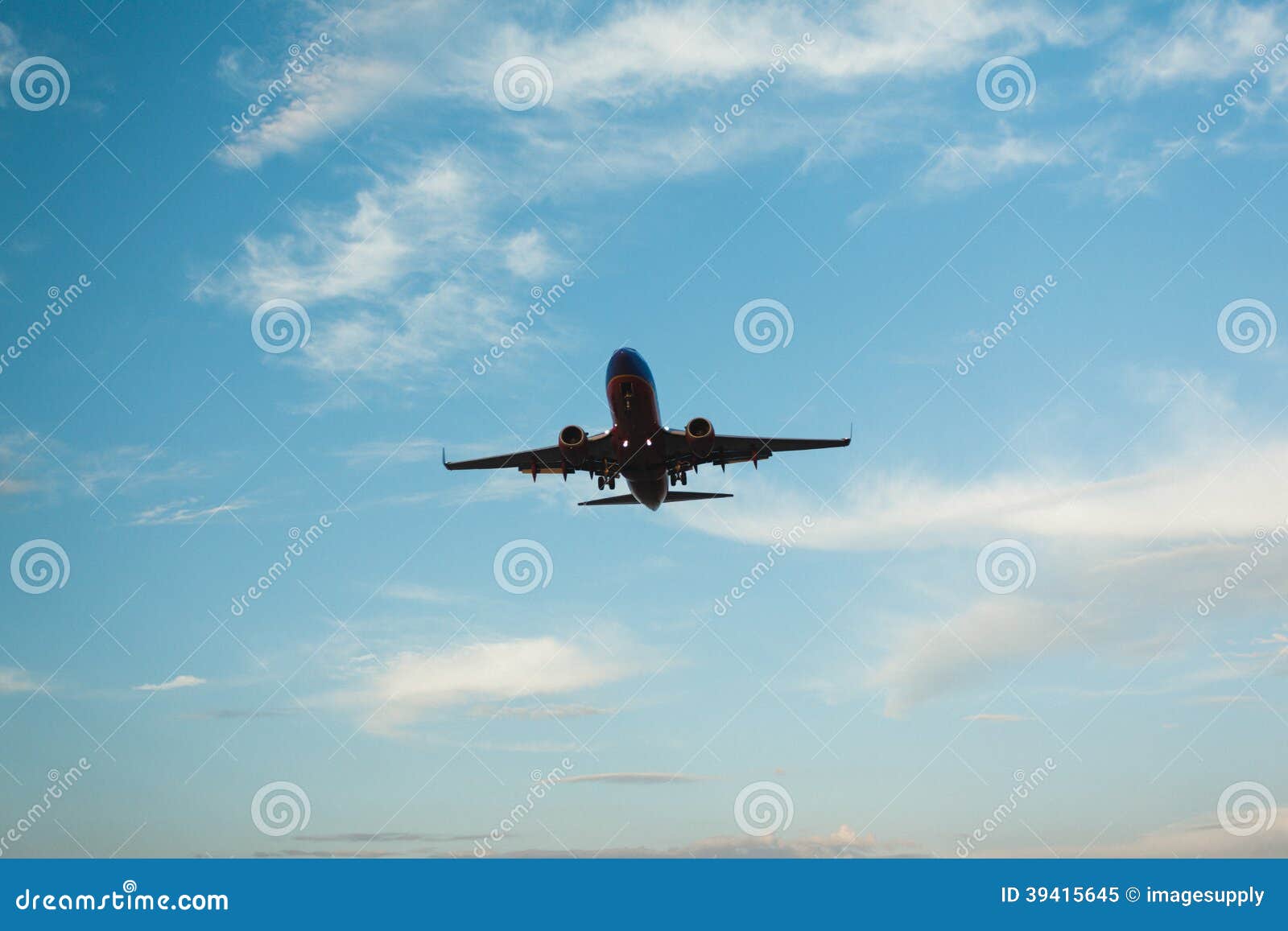 Plane Flying in with Pretty Blue Sky in Background Stock Image - Image ...