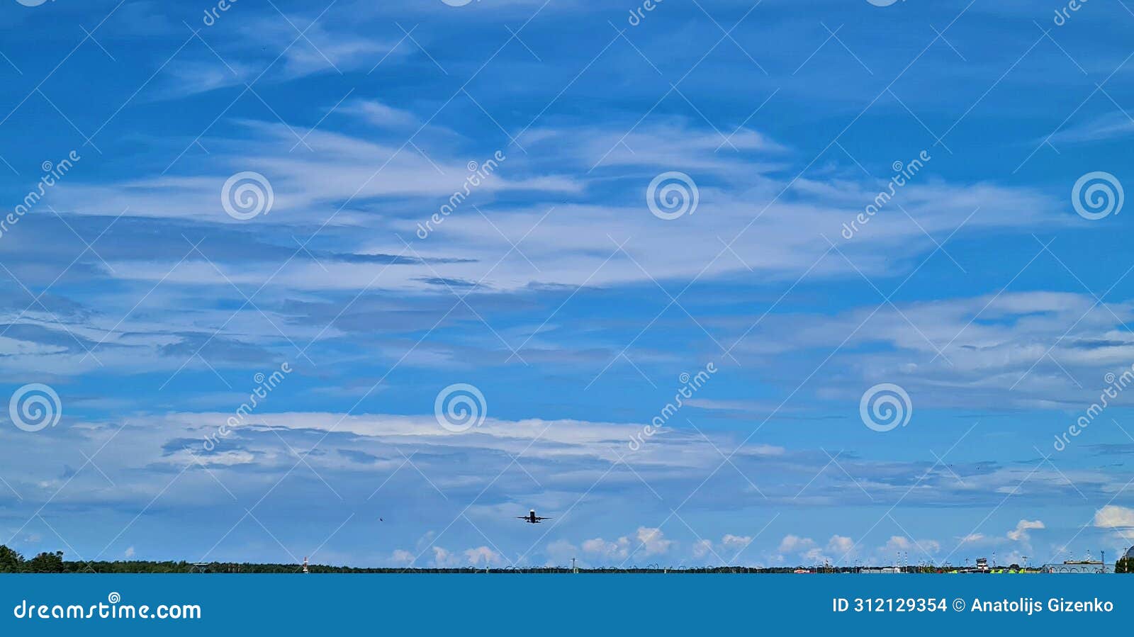 Plane Gains Altitude after Takeoff Against the Background of Blue ...