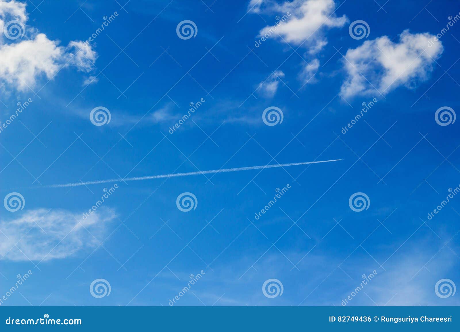 Plane Leaving White Lines Against the Blue Sky. Stock Photo - Image of ...