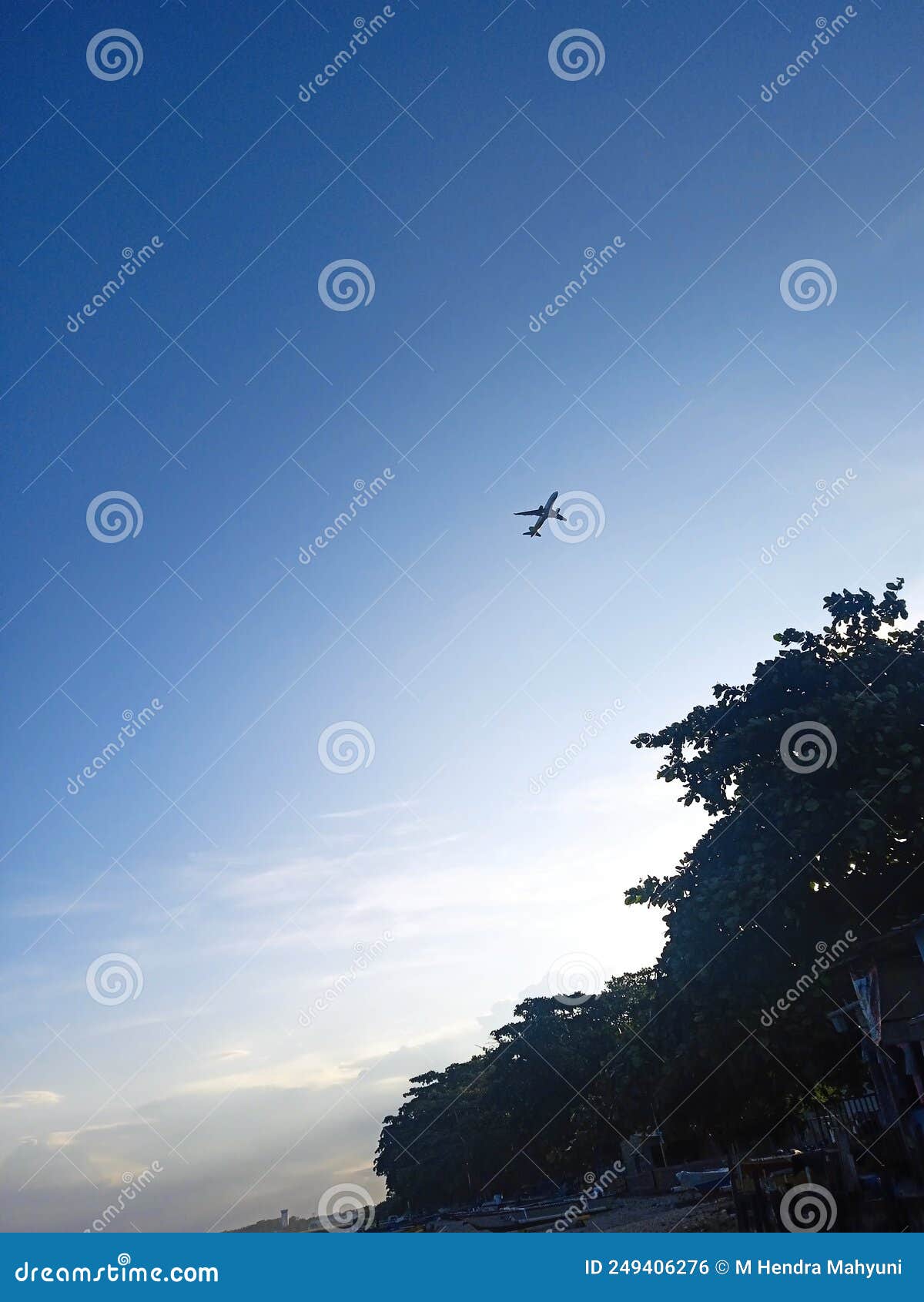Plane in Sky from Beach View Stock Photo - Image of ocean, sunset ...