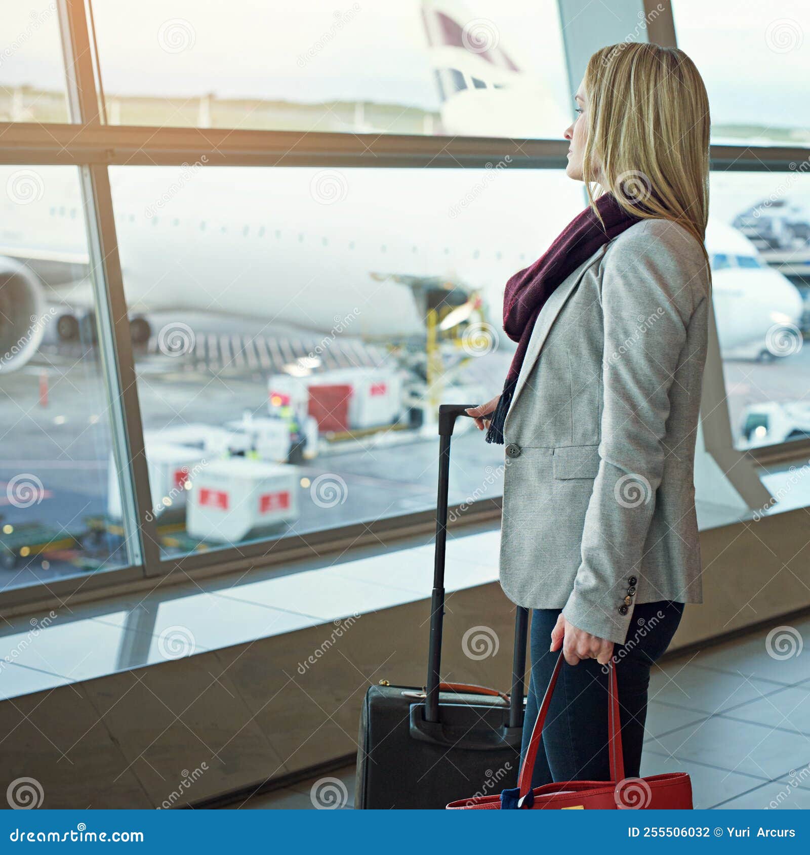 Plane Spotting. a Young Woman Standing in an Airport Looking Out the ... Plane Spotting. a Young Woman Standing in an Airport Looking Out the ...