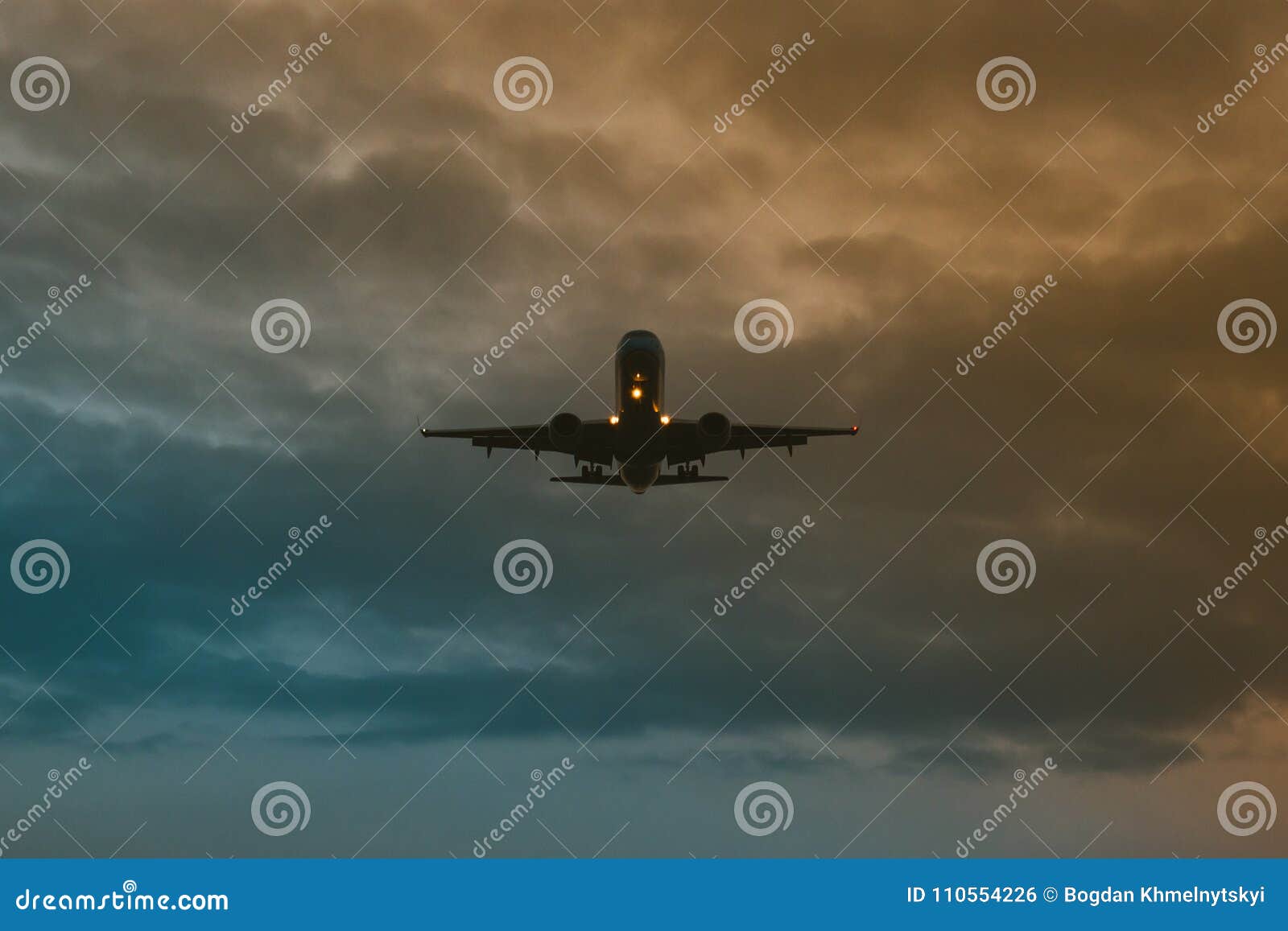 A Plane Taking Off on the Background of Dramatic Sky and Sunset Stock ...
