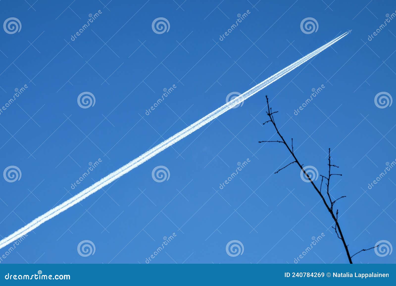 Jet Plane And Vapor Trails Going Straight Up Across A Cloudy Deep Blue ...