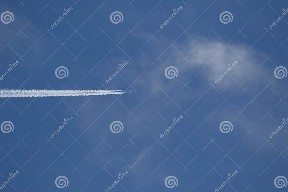 A Plane and Vapor Trails in the Sky Stock Photo - Image of plane ...
