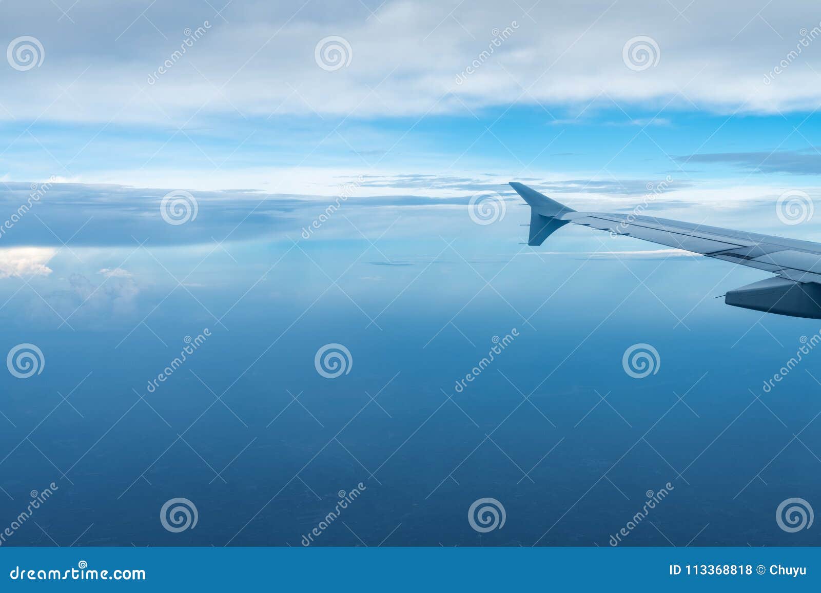 Plane wing view in the sky stock photo. Image of business - 113368818