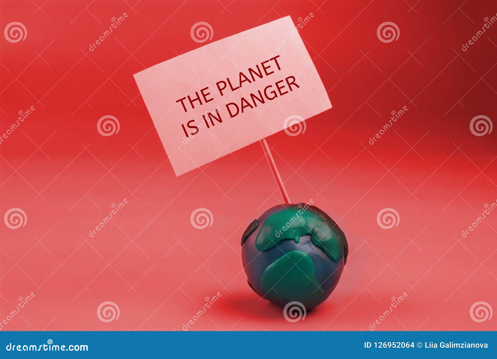 The Planet Earth in Danger Concept. Earth Holding a Banner Stock Photo ...
