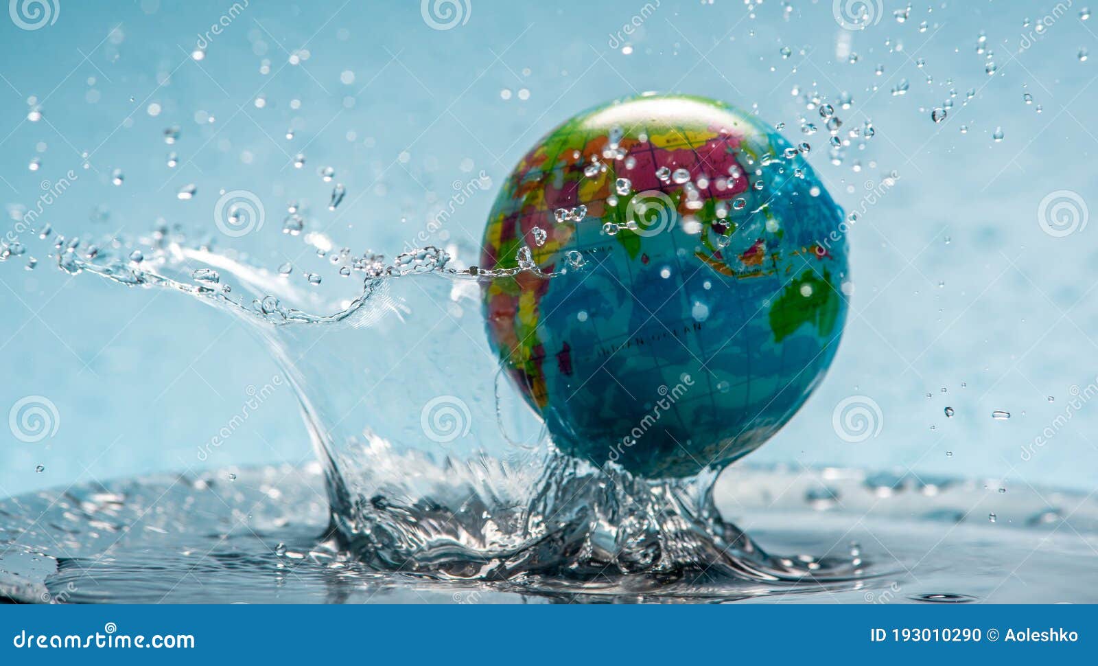 Planet Earth in the Form of a Globe in Clear Water with Splashes ...