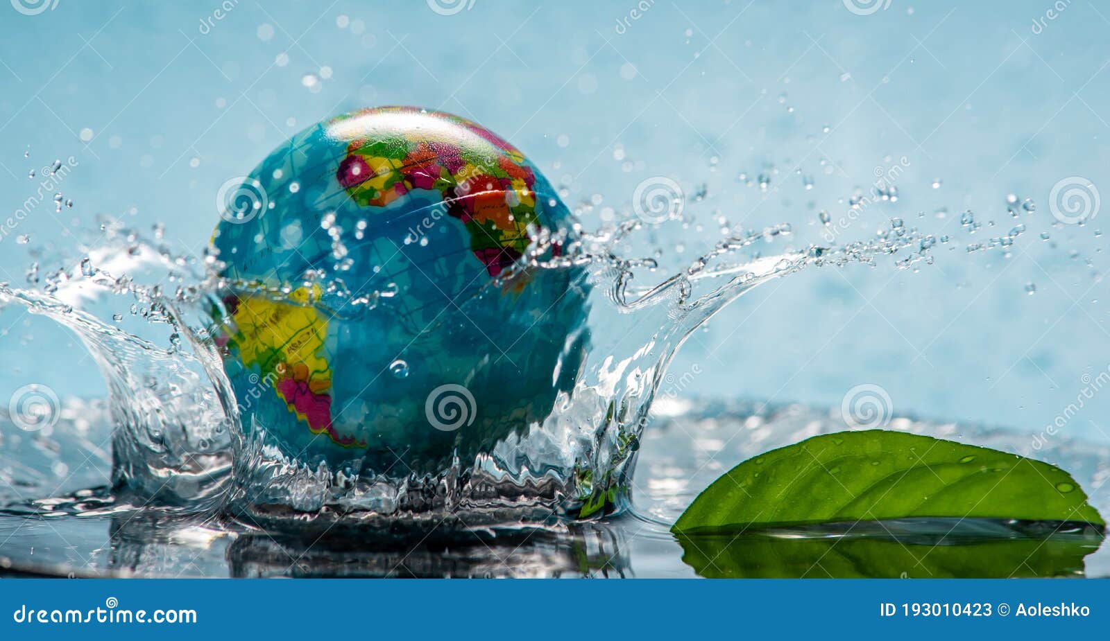 Planet Earth in the Form of a Globe in Clear Water with Splashes ...