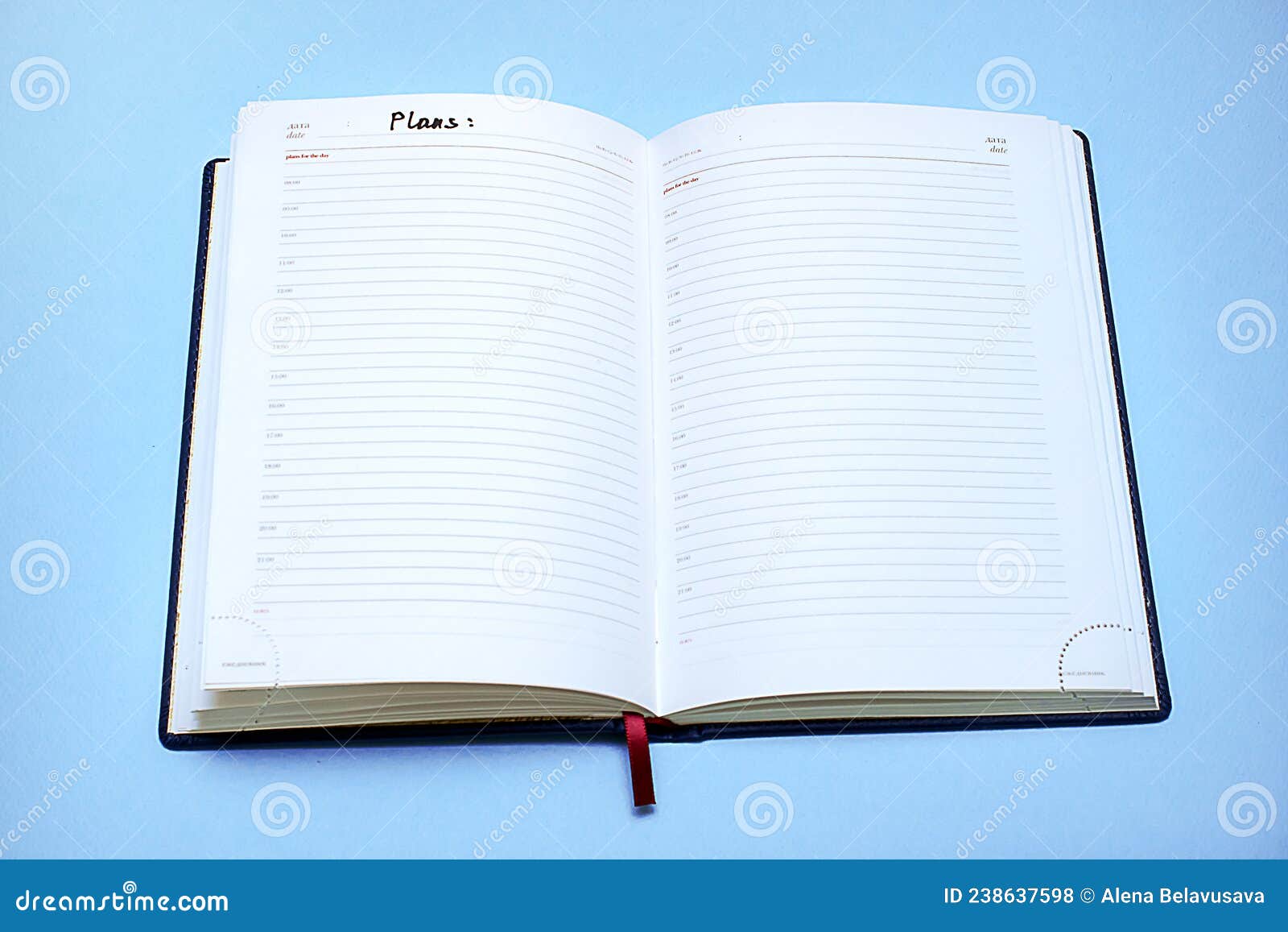 The Planner on a Blue Background is Open To a Blank Page at the Top of ...