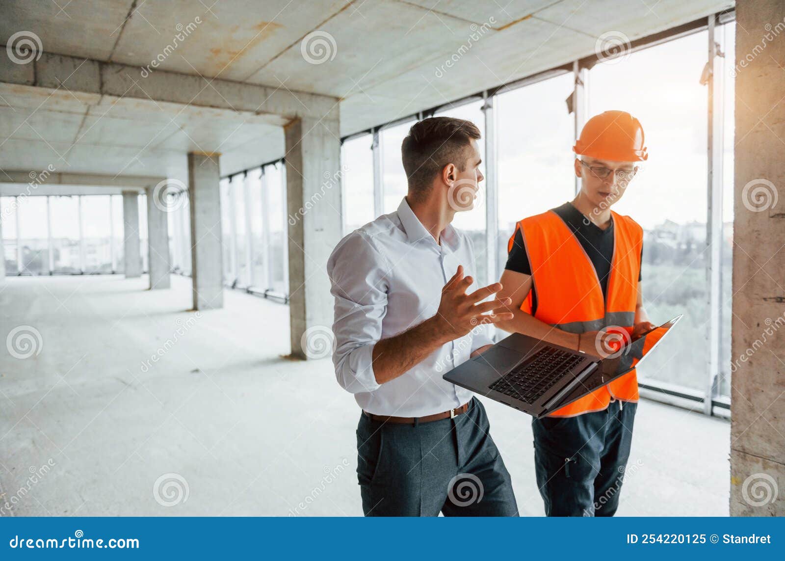 Planning the Process. Man in Suit and Handyman in Orange Protective ...