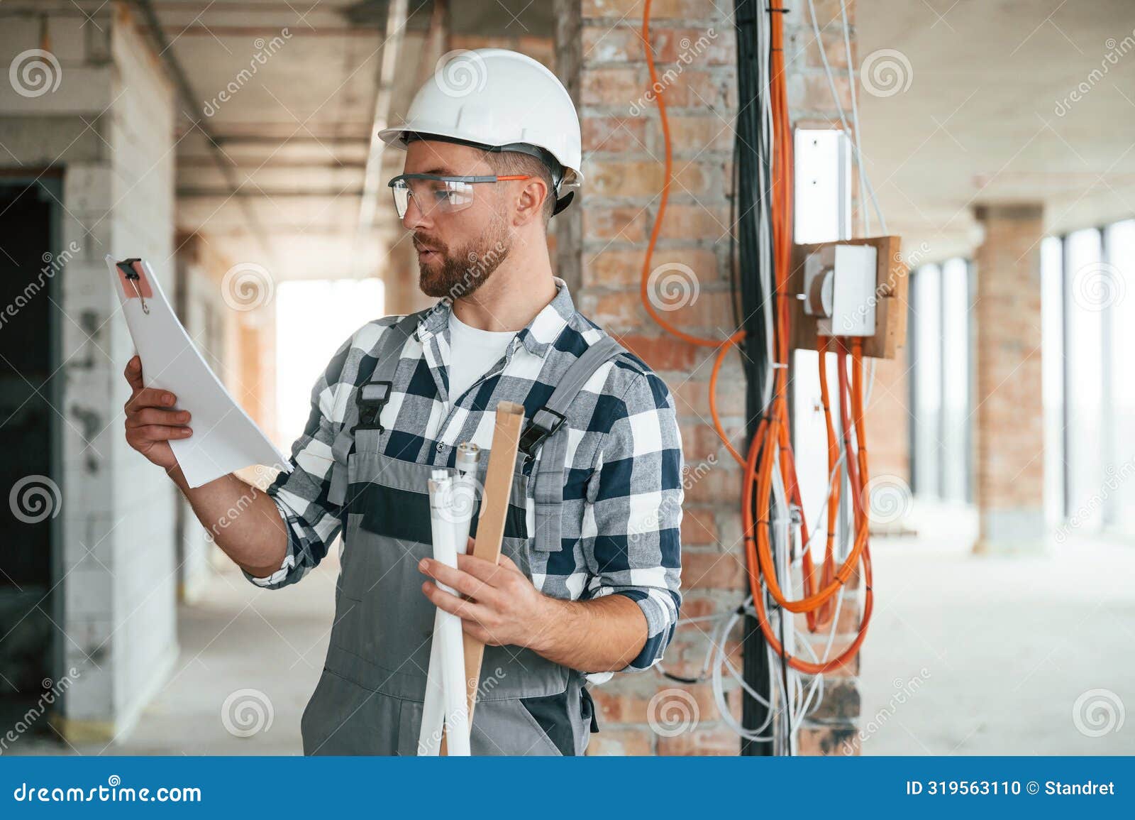 Planning the Project, with Paper. Construction Worker in Uniform in ...