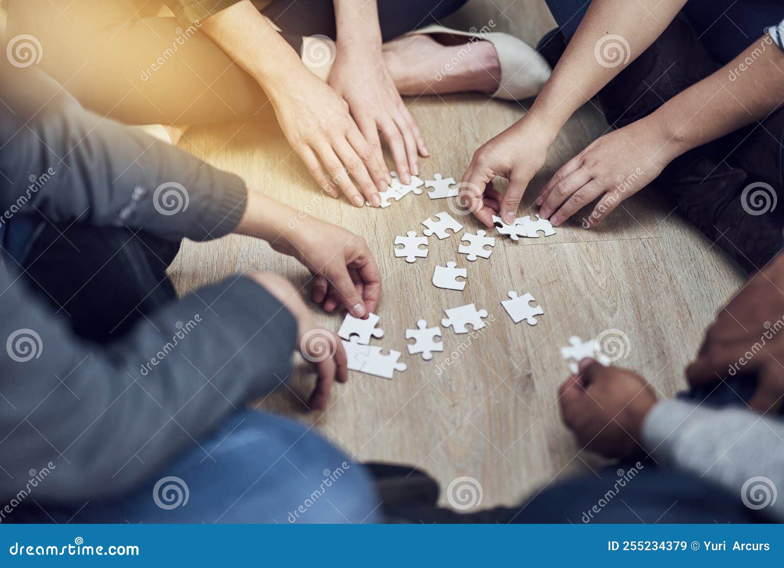 Planning the Puzzle. a Group of People Building a Puzzle Together ...