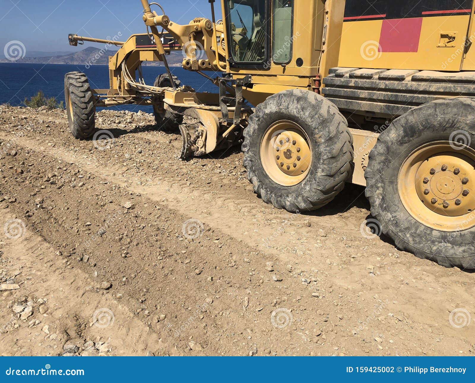 Planning of a Road Surface. Motor Grader during Road Construction Works ...