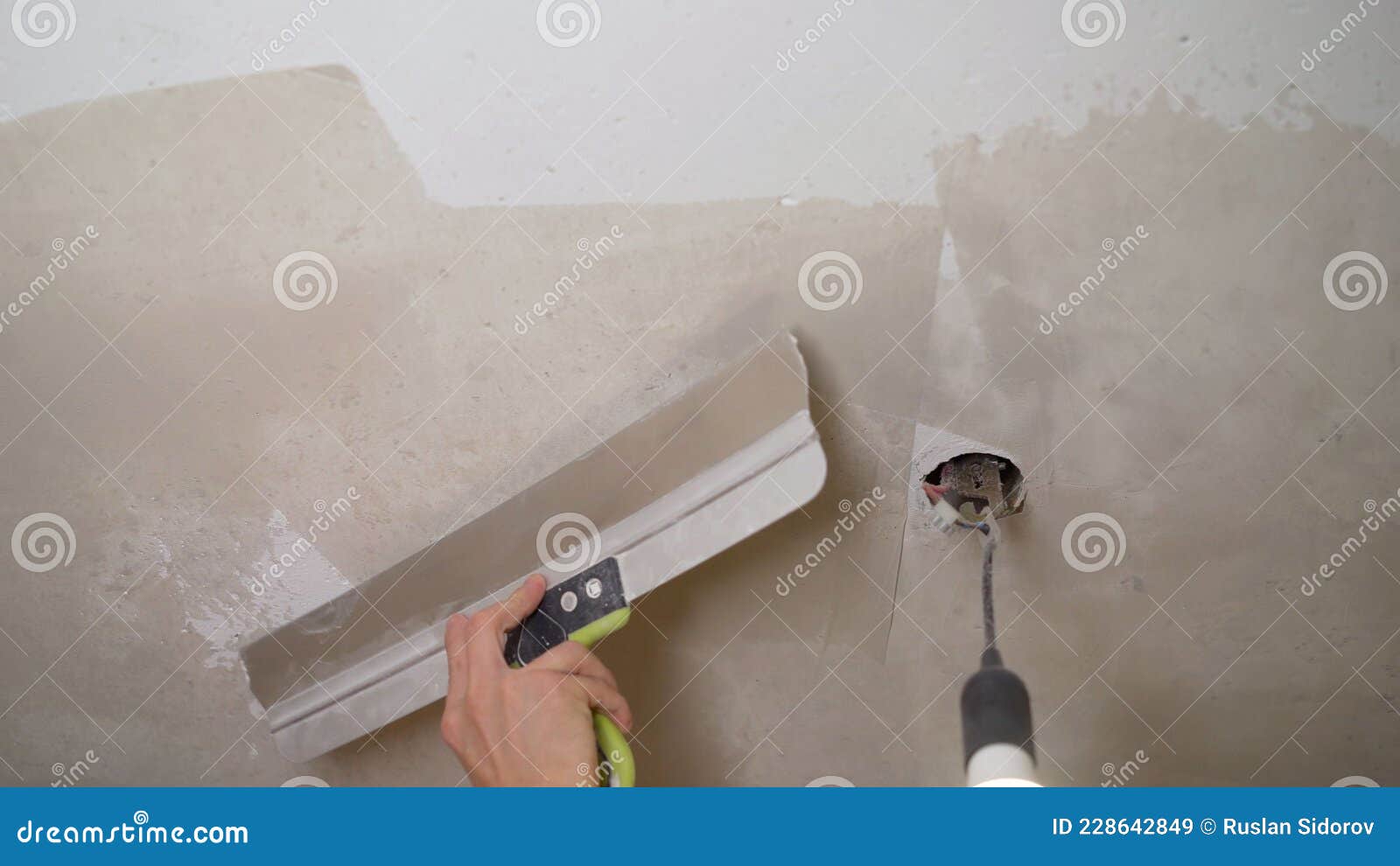 The Plasterer Levels The Wall Before Gluing The Wallpaper. The Process ...